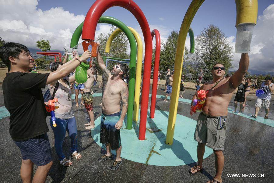 People enjoy splash of water during flash mob water fight in Vancouver ...