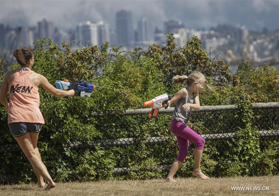 People enjoy splash of water during flash mob water fight in Vancouver ...