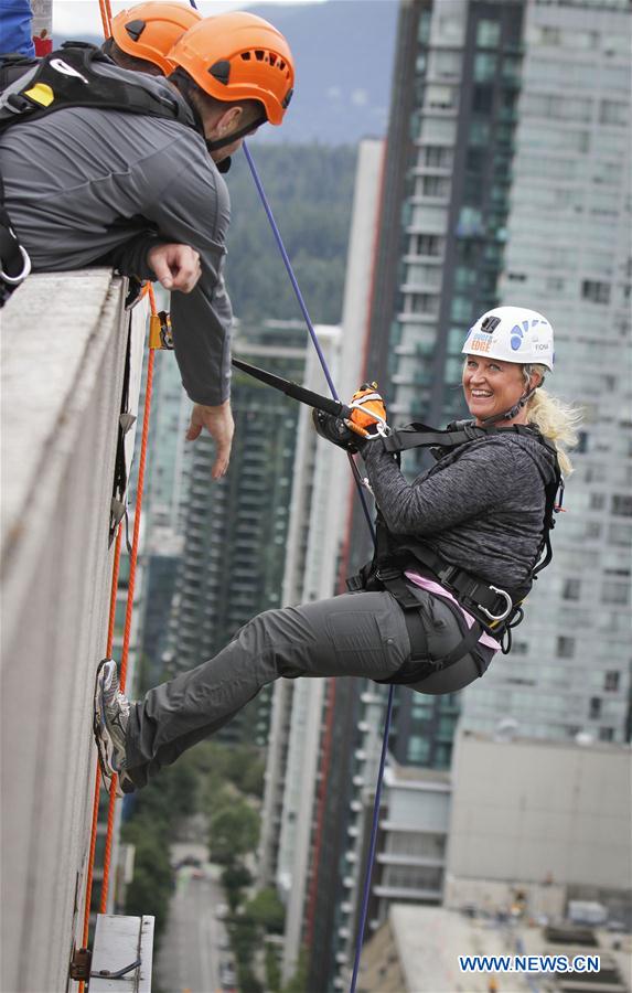 Fundraisers rappel off Vancouver skyscraper to help sick kids_English ...